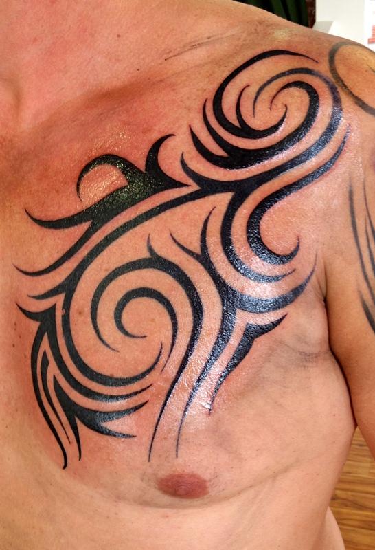 Tribal Shoulder And Chest Tattoo
